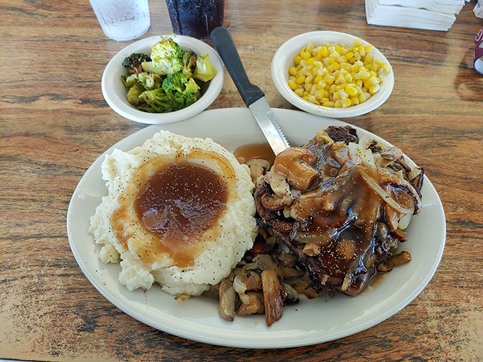 Salisbury steak swimming in rich gravy alongside creamy mashed potatoes. This plate doesn't just feed you&mdash;it hugs you from the inside.