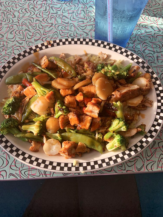 This stir-fry proves The Grand Diner isn't just about breakfast. Fresh vegetables and tender chicken create a colorful symphony on their signature checkered plate.