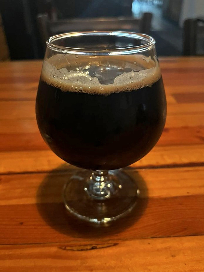 A proper stout—dark as midnight, rich as Rockefeller—stands ready to cut through burger decadence with malty sophistication.