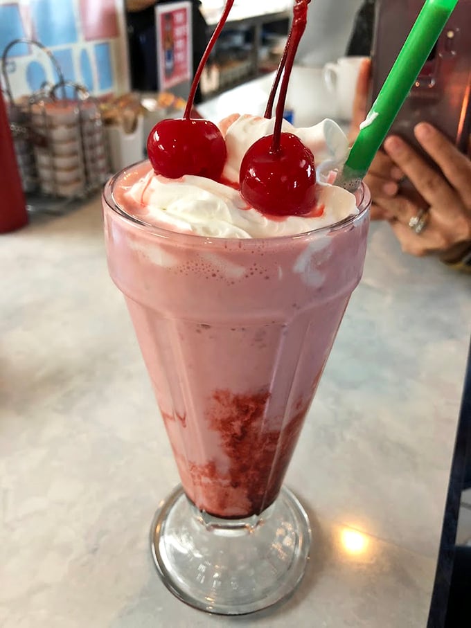 The strawberry milkshake arrives like a pink cloud topped with whipped cream and cherries &ndash; childhood nostalgia in a glass, but better than you remember.