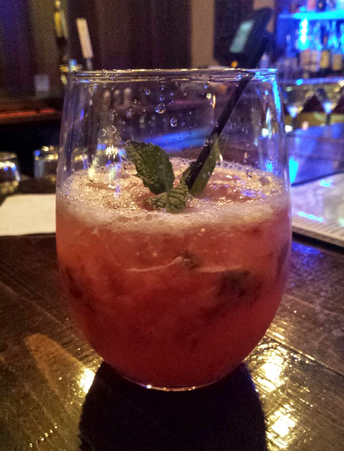 A strawberry mojito that's part cocktail, part vacation in a glass. The mint leaf isn't just garnish&mdash;it's sending you a personal invitation to relax.