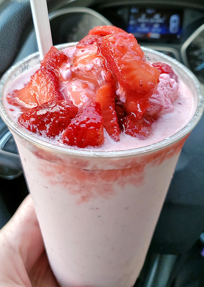 A strawberry shake so thick it defies gravity and physics. The straw stands at attention, awaiting your worthy effort.