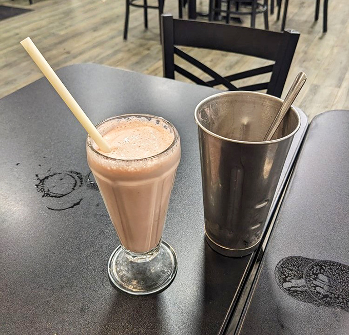 A classic strawberry milkshake in its natural habitat &ndash; thick enough for a spoon, served in the traditional metal mixing cup for seconds.