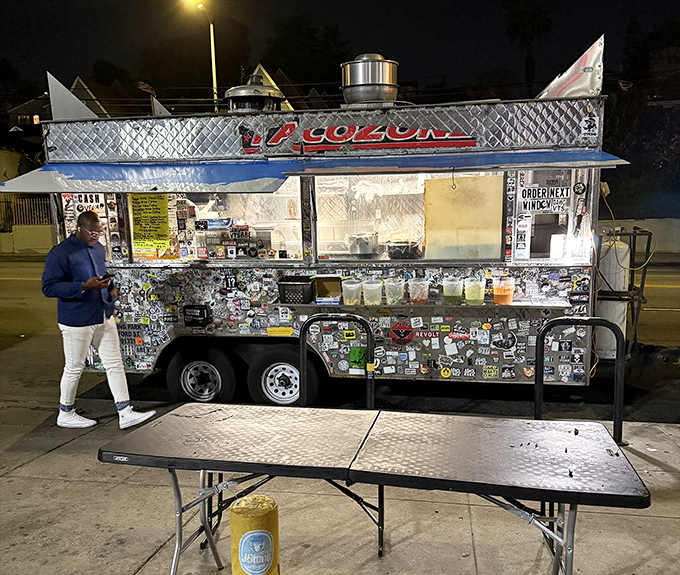The spartan dining setup adds to the experience—because some meals are meant to be eaten standing up, illuminated by truck lights and anticipation.