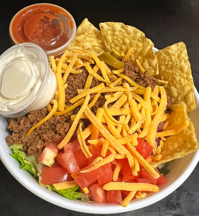 Taco salad that's basically a fiesta in a bowl with enough cheese to make Wisconsin jealous.