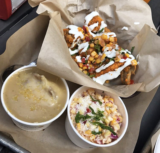 A feast for both eyes and stomach&mdash;crispy chicken, creamy sides, and what appears to be a corn salad creating the holy trinity of comfort food.