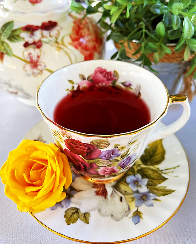 Tea served with the respect it deserves. That yellow rose isn't just decoration&mdash;it's setting the stage for a proper moment of pause.