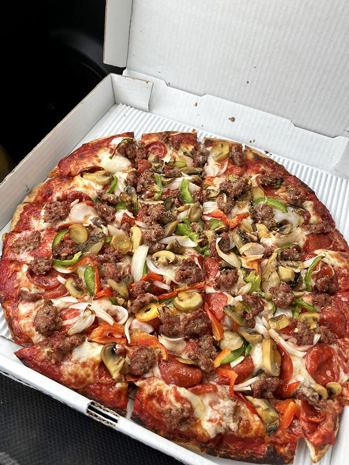 When toppings join forces like the Avengers of flavor—mushrooms, sausage, and peppers creating superhero-level deliciousness on Terita's Special Pizza.