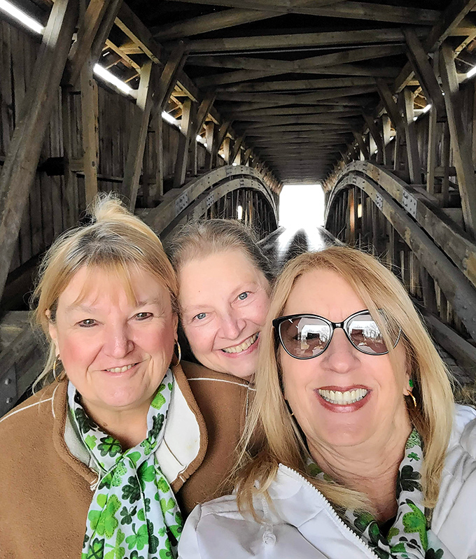 Bridge enthusiasts share a moment of joy inside the historic structure, their smiles as bright as the light at the tunnel's end.