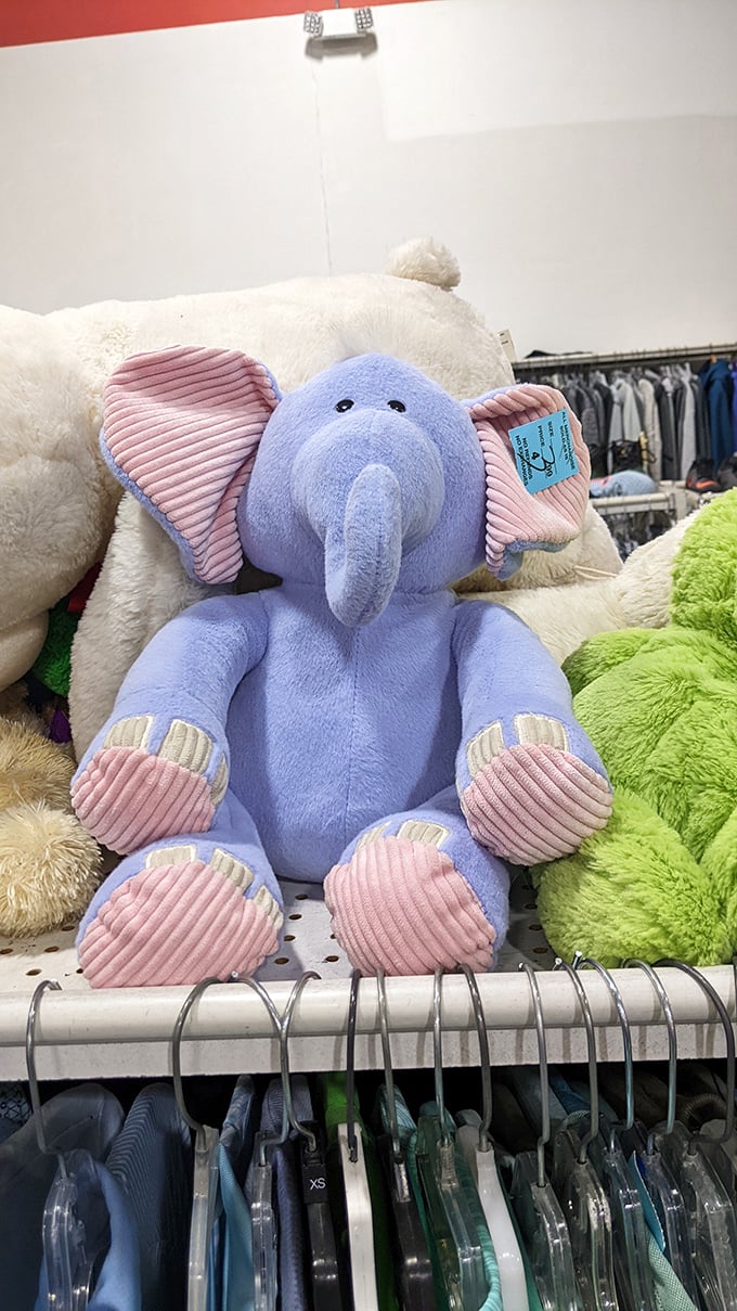 This blue elephant plush toy is waiting for its forever home, looking slightly bewildered by its journey from nursery to thrift store shelf.