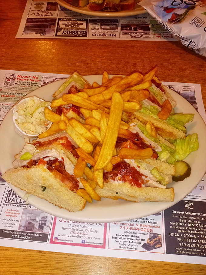 The club sandwich—architecture you can eat. Those perfectly golden fries aren't just a side dish; they're essential supporting characters in this lunch drama.