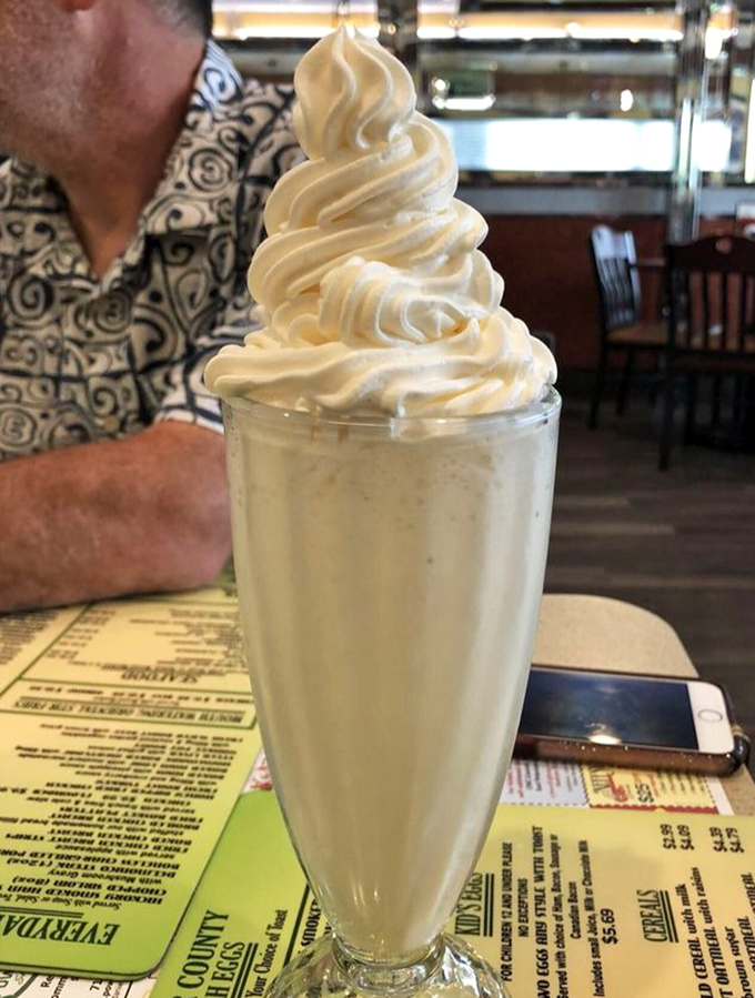 That's not just a milkshake&mdash;it's a monument to dairy perfection. The whipped cream tower demands respect and a spoon backup plan. 