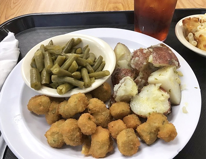 Southern vegetables elevate from side dish to main event - those fried okra nuggets and red potatoes are having a flavor conversation worth eavesdropping on.