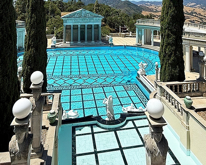 The Neptune Pool from above reveals its true grandeur &ndash; a shimmering jewel set among classical columns with the rolling California hills beyond.