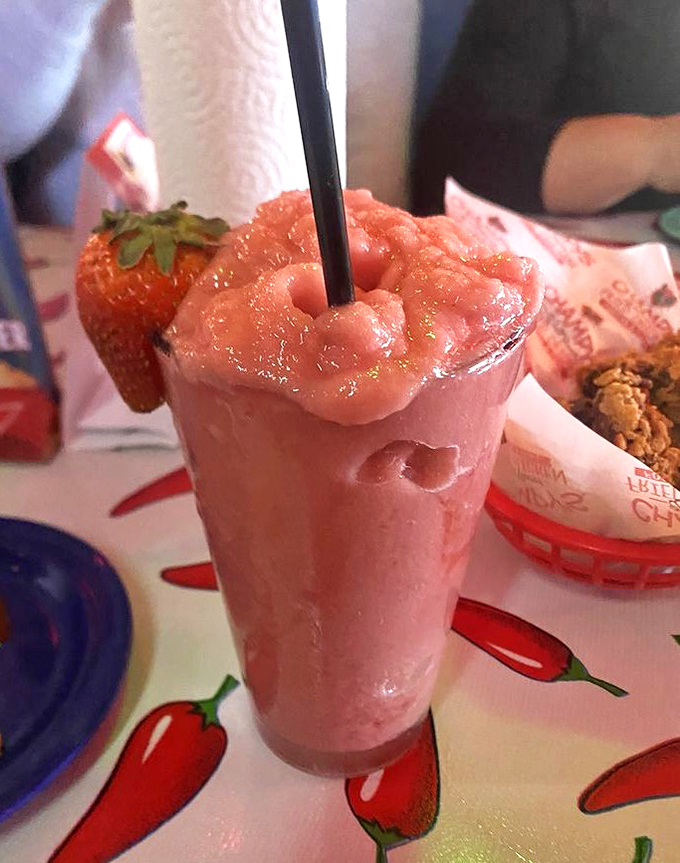 A strawberry daiquiri topped with fresh fruit&mdash;the kind of drink that makes you forget you're technically having dessert first.