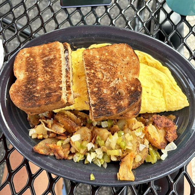 Breakfast sandwich architecture at its finest &ndash; perfectly grilled bread embracing fluffy eggs and savory fillings like old friends at a reunion.