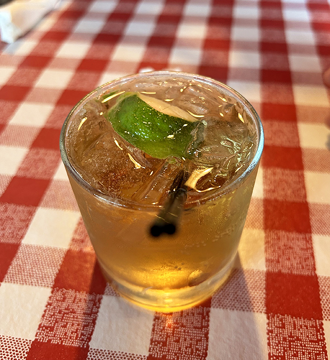 Nothing says "vacation mode activated" quite like a white sangria with a lime twist on a checkered tablecloth.