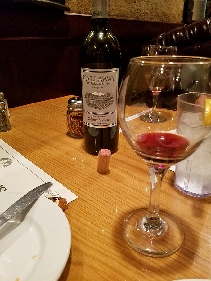 A glass of Callaway Cabernet Sauvignon waiting to complement your meal&mdash;because good Italian food deserves good wine, and good conversations deserve both.