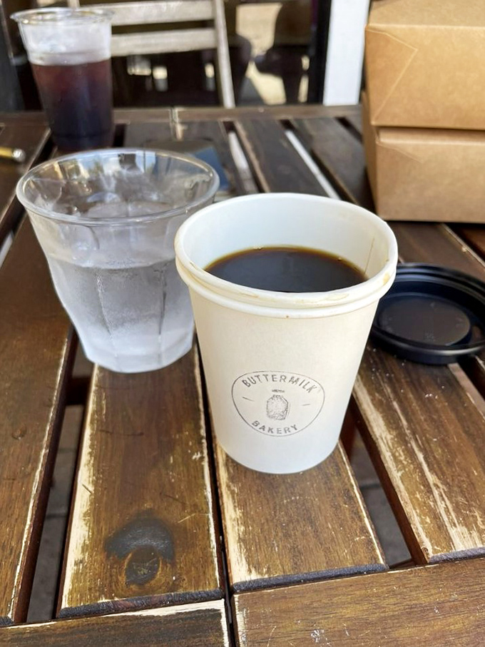Coffee served in a cup bearing the bakery's logo&mdash;a simple pleasure that says, "Take a moment, slow down, this sip deserves your full attention."