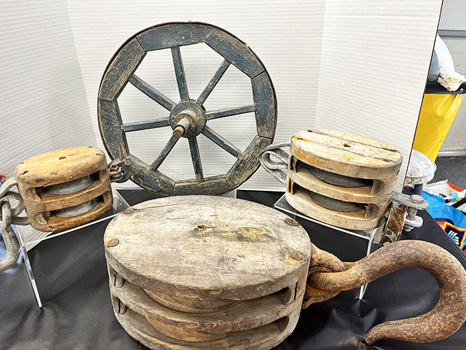 These weathered wooden wheels and pulleys aren't just antiques—they're mechanical poetry from an era when things were built to outlast their makers.