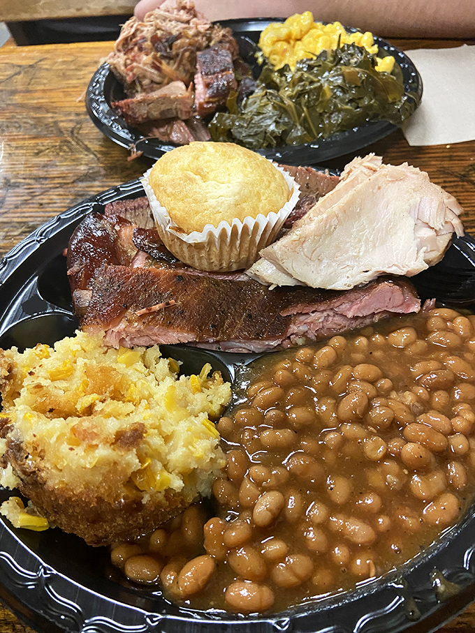 A symphony in three movements: tender meat, collard greens swimming in pot liquor, and baked beans that have clearly been introduced to the brisket at some point.