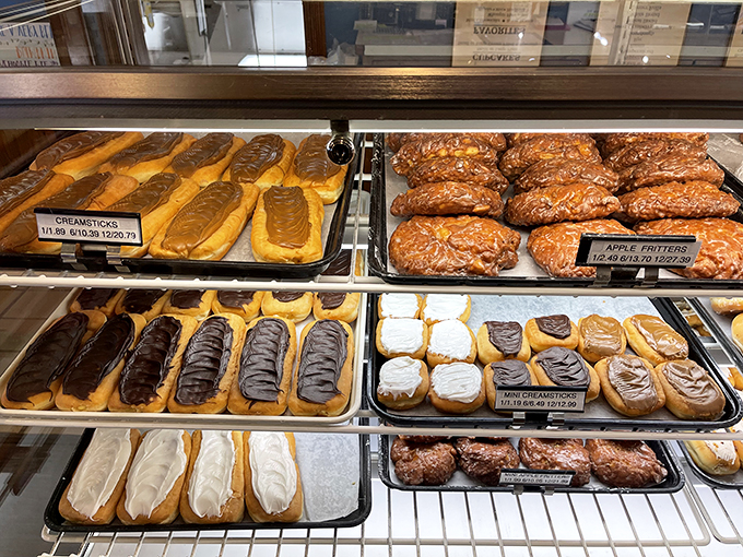 The pastry case doubles as a museum of baking excellence, where cream sticks and apple fritters compete for your affection like delicious rivals.