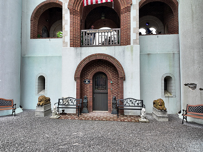 A royal welcome awaits at this ornate entryway. Stone benches flank the door while decorative lions stand guard, offering both hospitality and a hint of medieval majesty. 