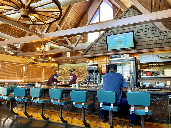 The counter isn't just seating—it's front-row tickets to the breakfast show, where coffee flows freely and regulars exchange desert wisdom.