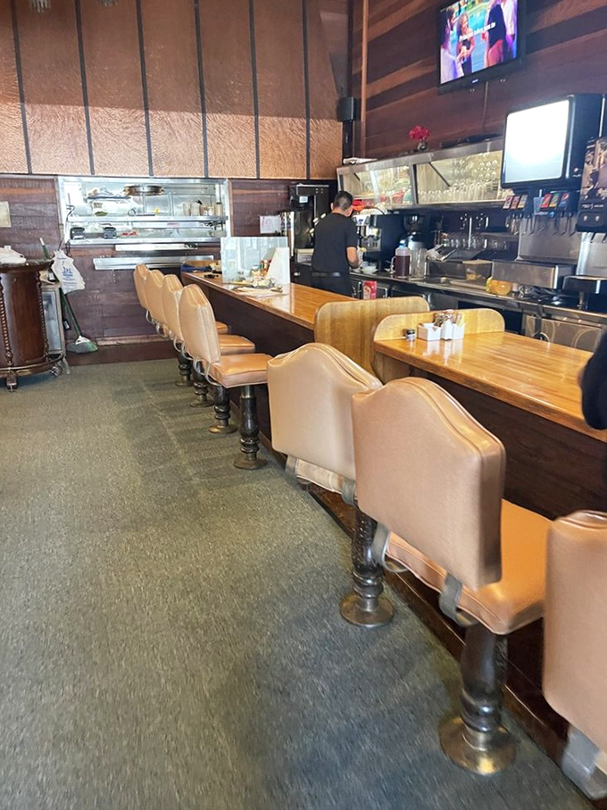 The counter seats—where solo diners become regulars, and the coffee refills come with a side of neighborhood gossip.
