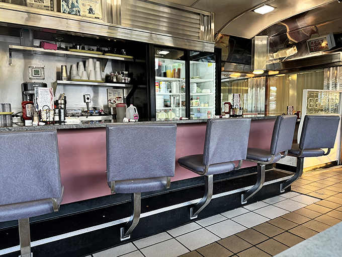 The heart of any great diner – a counter where strangers become friends and the coffee never stops flowing.