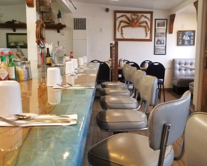 The counter seating offers front-row tickets to the culinary show, with that magnificent crab display reminding you exactly where you are.