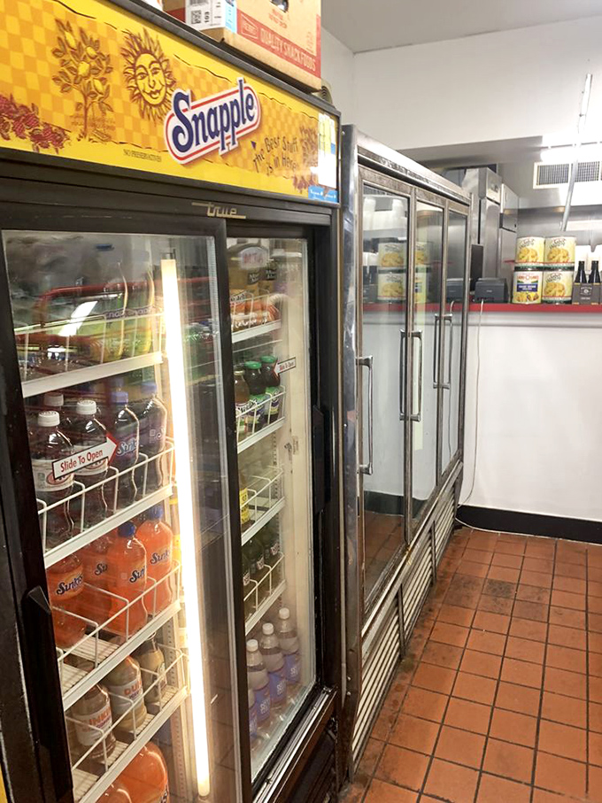 The beverage cooler&mdash;where every Snapple bottle waits for its destiny as the perfect hoagie companion. Hydration is serious business here.