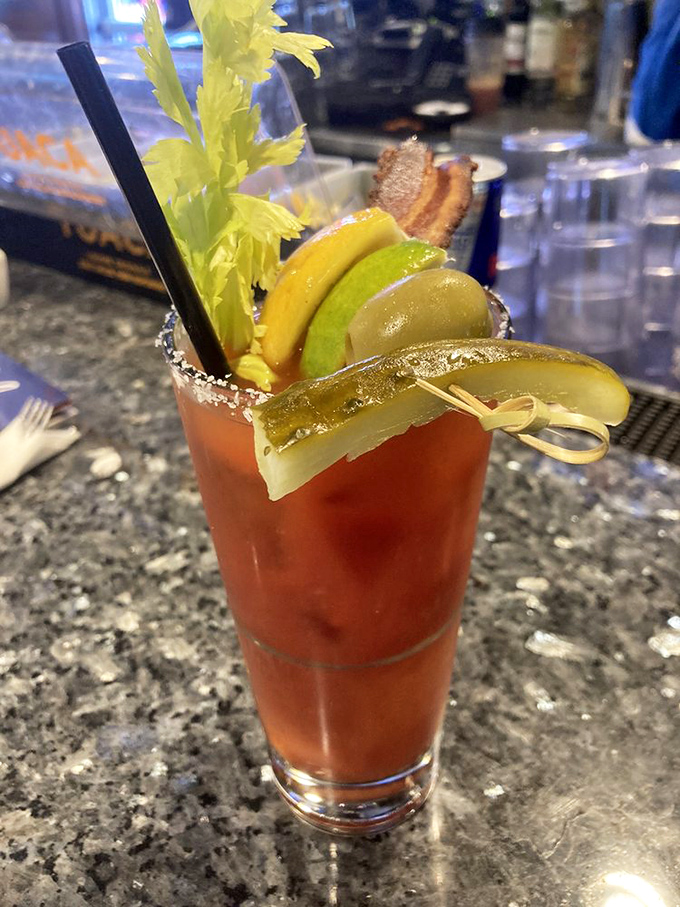 A Bloody Mary adorned like it's heading to breakfast prom &ndash; celery stalk, bacon strip, and enough garnishes to qualify as a small salad.