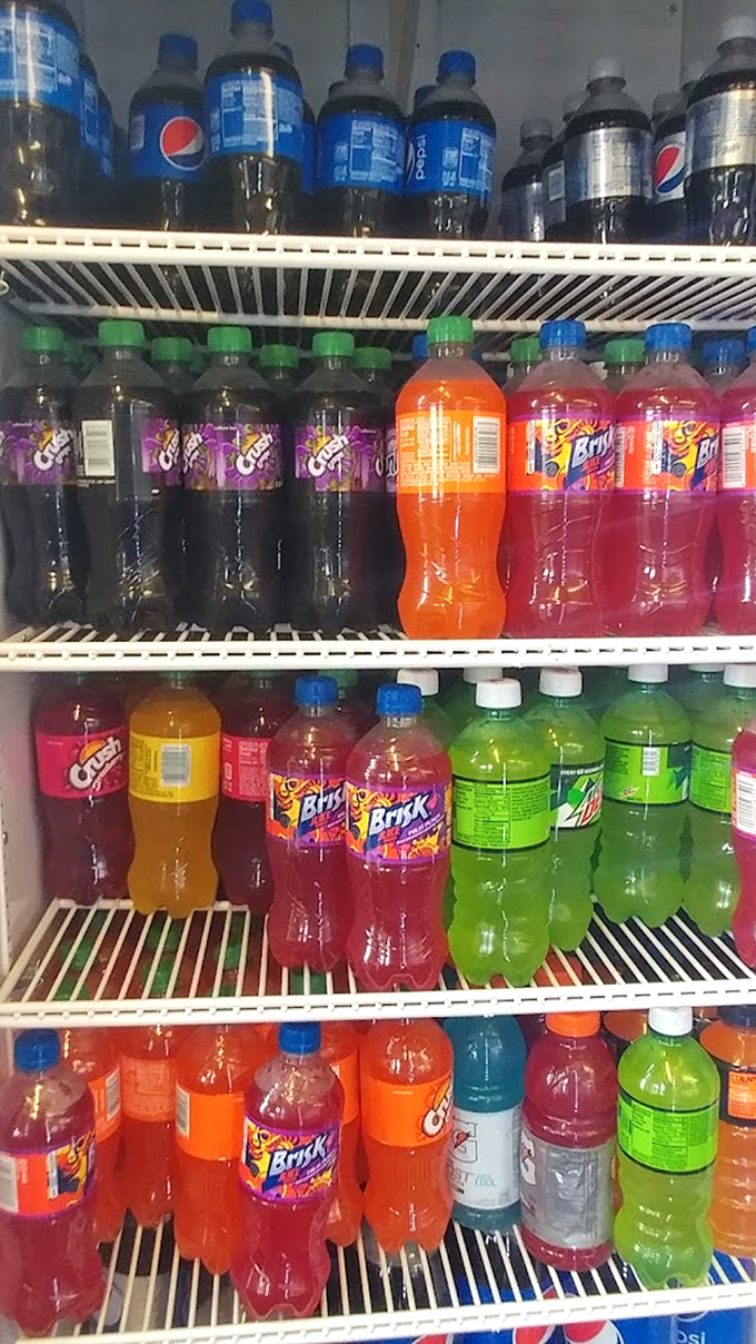 The beverage case—where neon-colored sodas stand ready to cut through the richness of your sandwich. Brisk and Crush, the unsung heroes.