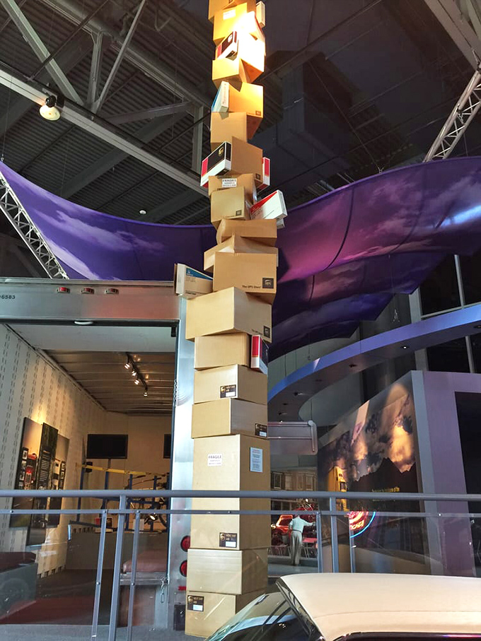 Art meets engineering in this towering installation of stacked boxes, creating a vertical timeline of transportation innovation that reaches toward the museum's industrial ceiling.