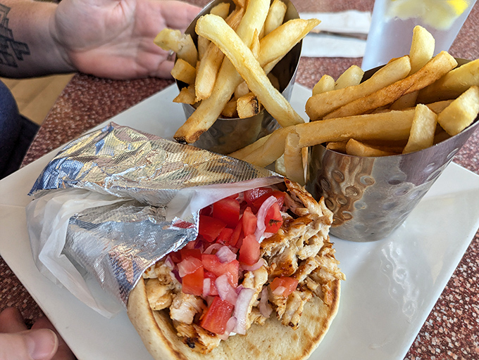 Gyro perfection wrapped up with those golden fries standing at attention. This isn't fast food; it's food made with care, served fast.