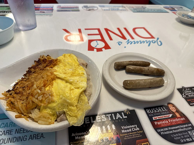 Breakfast hash browns crisped to golden perfection alongside eggs and sausage&mdash;the holy trinity of morning meals that makes waking up worthwhile.
