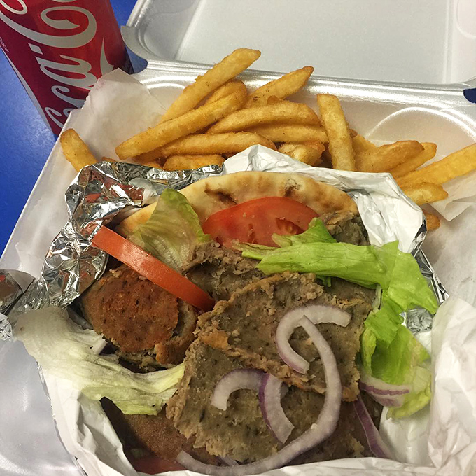 A sandwich that demands two hands and your undivided attention, flanked by fries that deserve their own fan club.