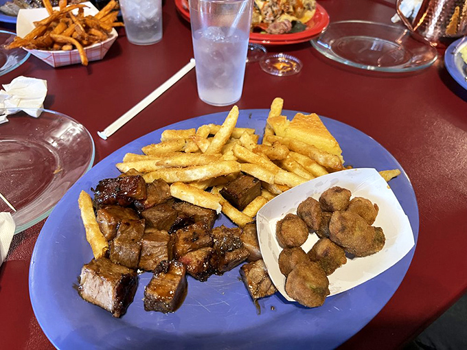 Burnt ends&mdash;those magical meat candy cubes&mdash;share the plate with golden fries and hush puppies in a trifecta of comfort food perfection.