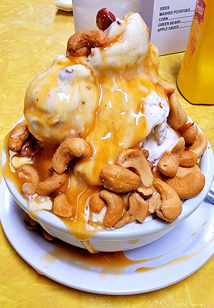 Butterscotch cascading over vanilla ice cream like liquid gold, with cashews standing guard. This isn't dessert&mdash;it's therapy in a bowl.