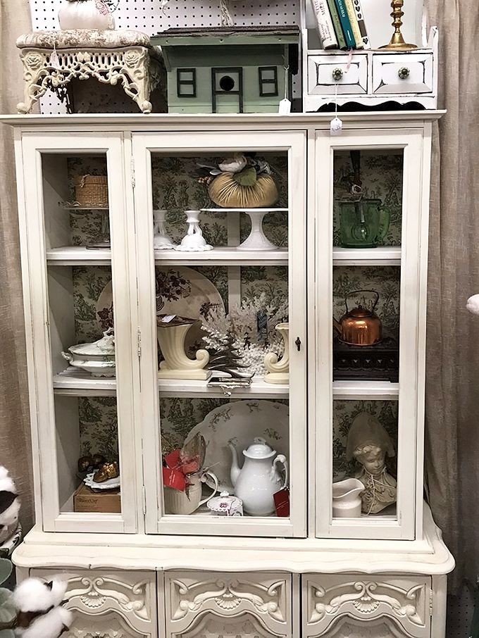 Behind these glass doors lies a curated collection of porcelain perfection, each piece whispering tales of formal dinners and special occasions past.