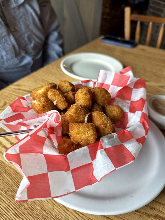 Those cheese curds look like they're wearing little golden jackets, dressed up for the most delicious party your mouth will ever attend.