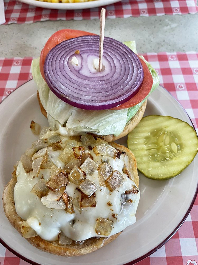 The open-faced burger revelation nobody warned me about! Melted cheese cascading over saut&eacute;ed onions and mushrooms&mdash;a knife-and-fork affair worth the extra napkins.