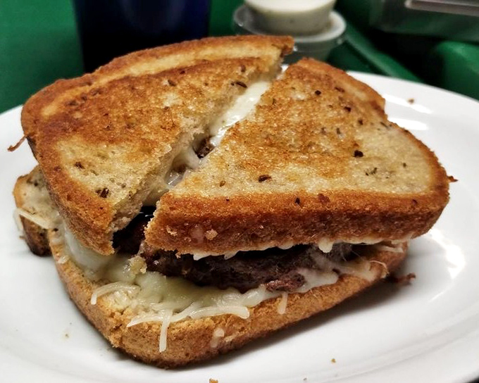 This patty melt isn't just grilled &ndash; it's been transformed into a buttery, cheesy masterpiece that would make your cardiologist wince and your taste buds sing.