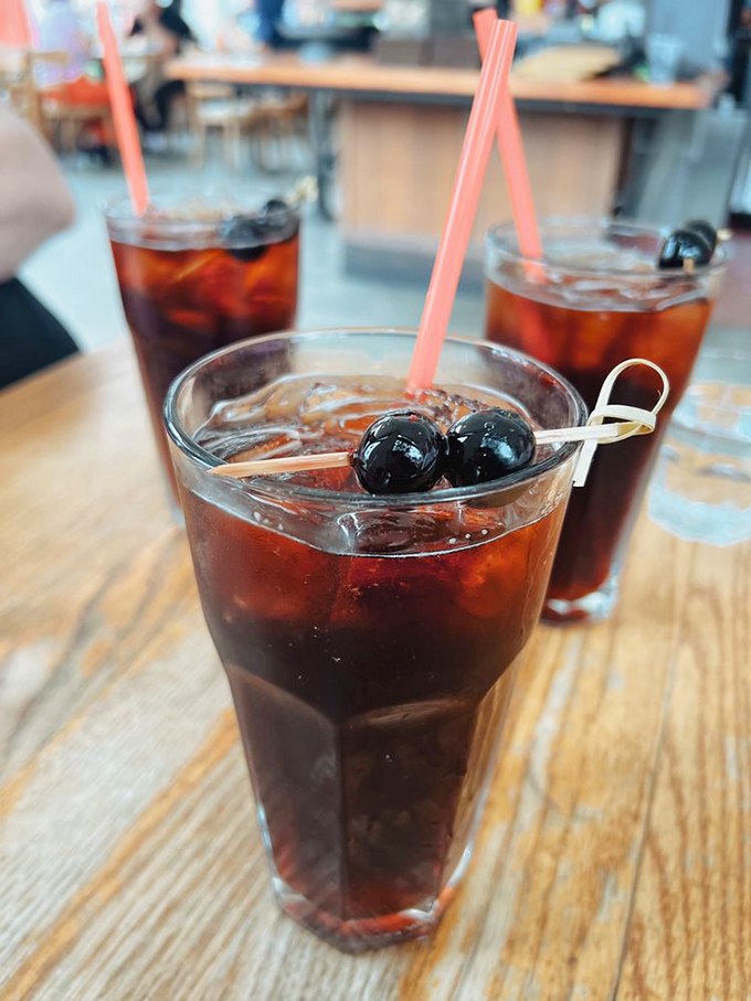 Nothing says "I'm about to enjoy something wonderful" quite like cherry colas with actual cherries. Nostalgia you can sip through a straw.