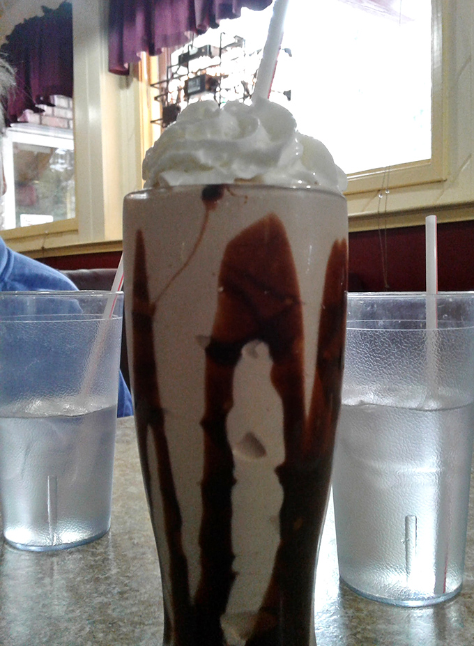 Not just a chocolate milkshake, but a tower of indulgence tall enough to have its own zip code, crowned with a cloud of whipped cream.