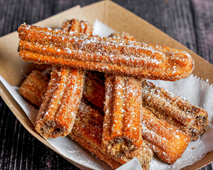 Churros that look like they've been dusted by a sugar fairy&mdash;crunchy, sweet magic wands that disappear faster than you can say "dessert."