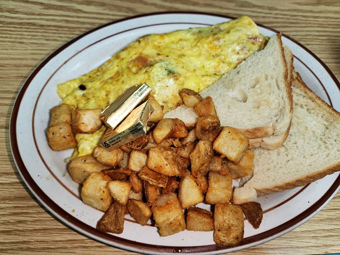 Breakfast perfection: a golden omelet, crispy home fries, and toast&mdash;the holy trinity of morning satisfaction that never disappoints.