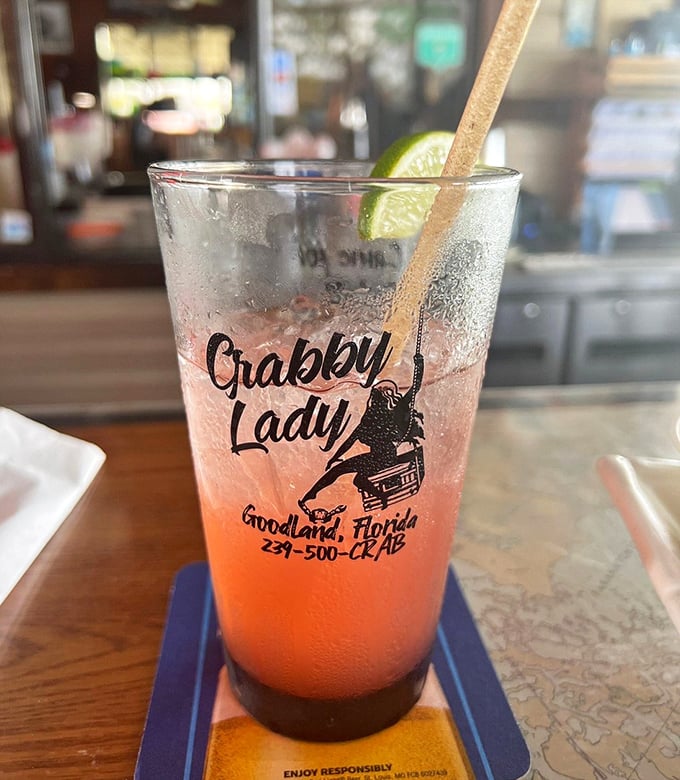Sunset in a glass! This refreshing cocktail with its gradient of colors captures Florida's laid-back spirit—complete with branded souvenir glass.