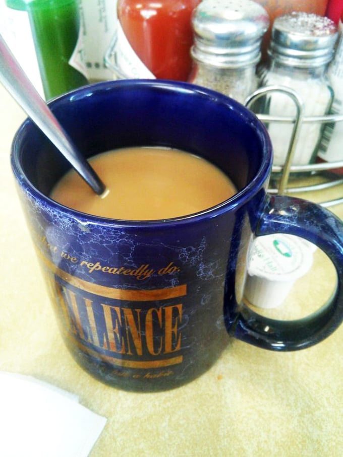 That blue mug doesn't just hold coffee; it cradles liquid motivation that's kept Tucson running for decades, no fancy foam art required.